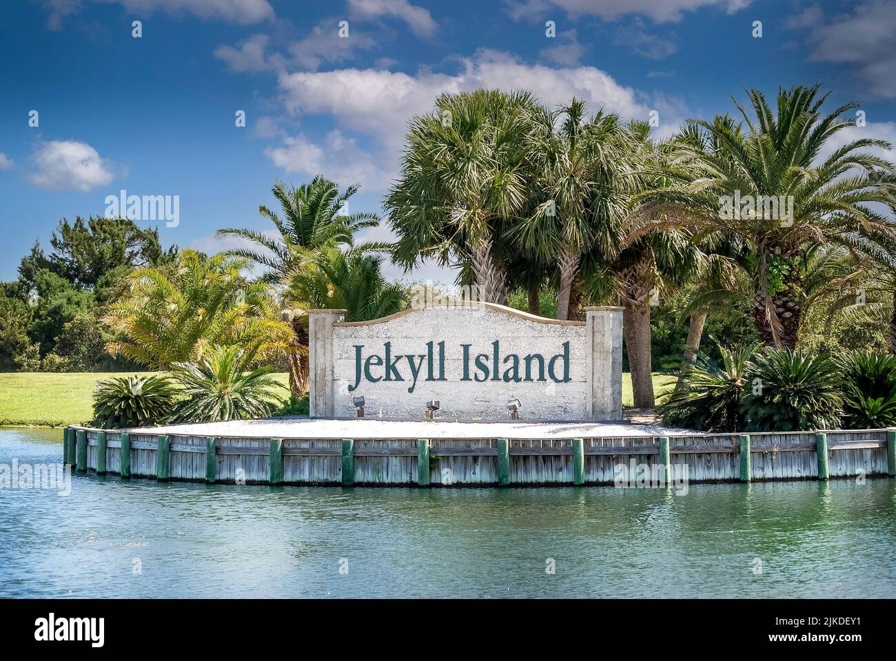 Jekyll Island, Georgia sign as you enter the sign with palm trees and water around the sign ...