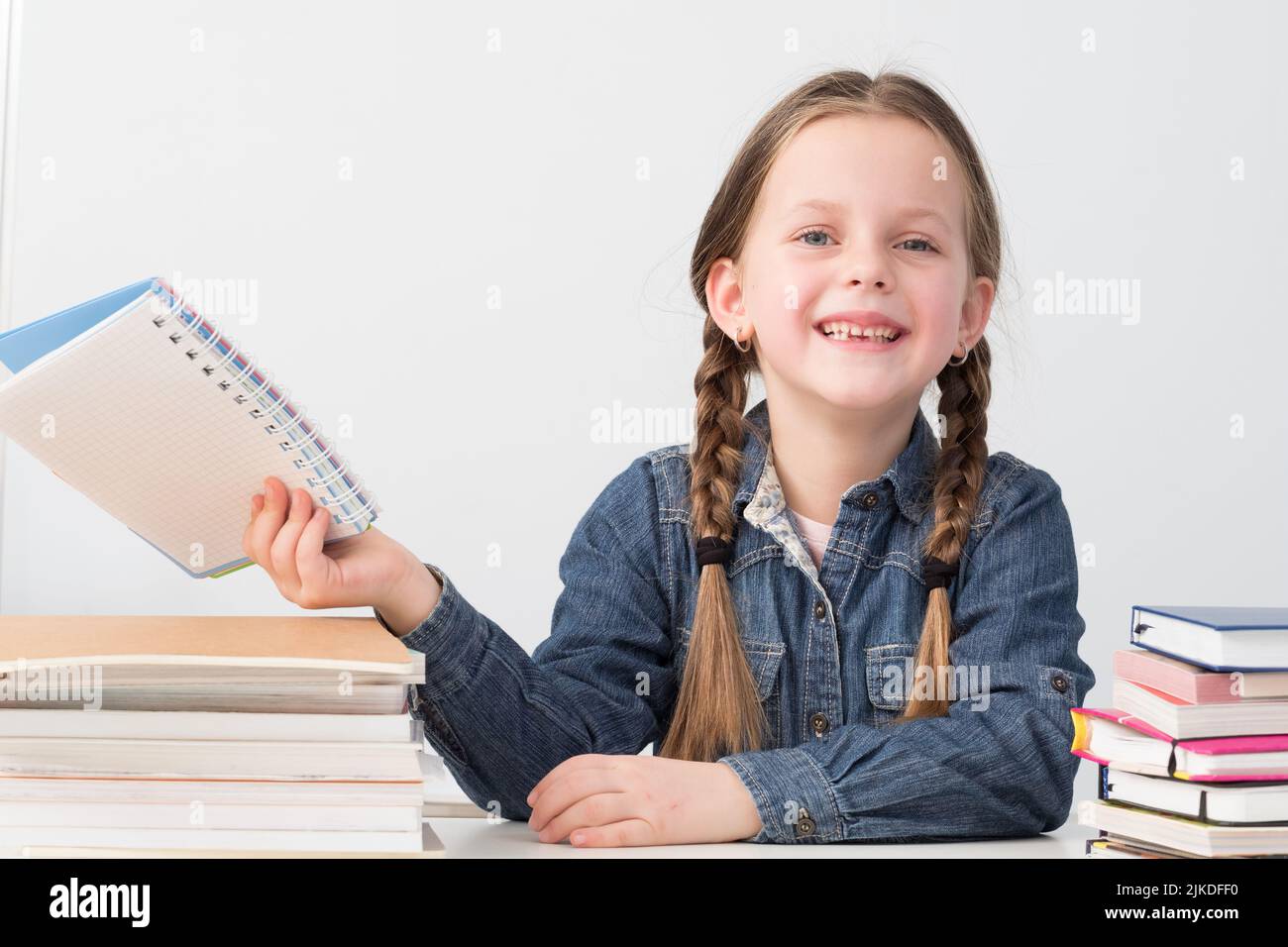 primary education smiling happy school girl books Stock Photo - Alamy