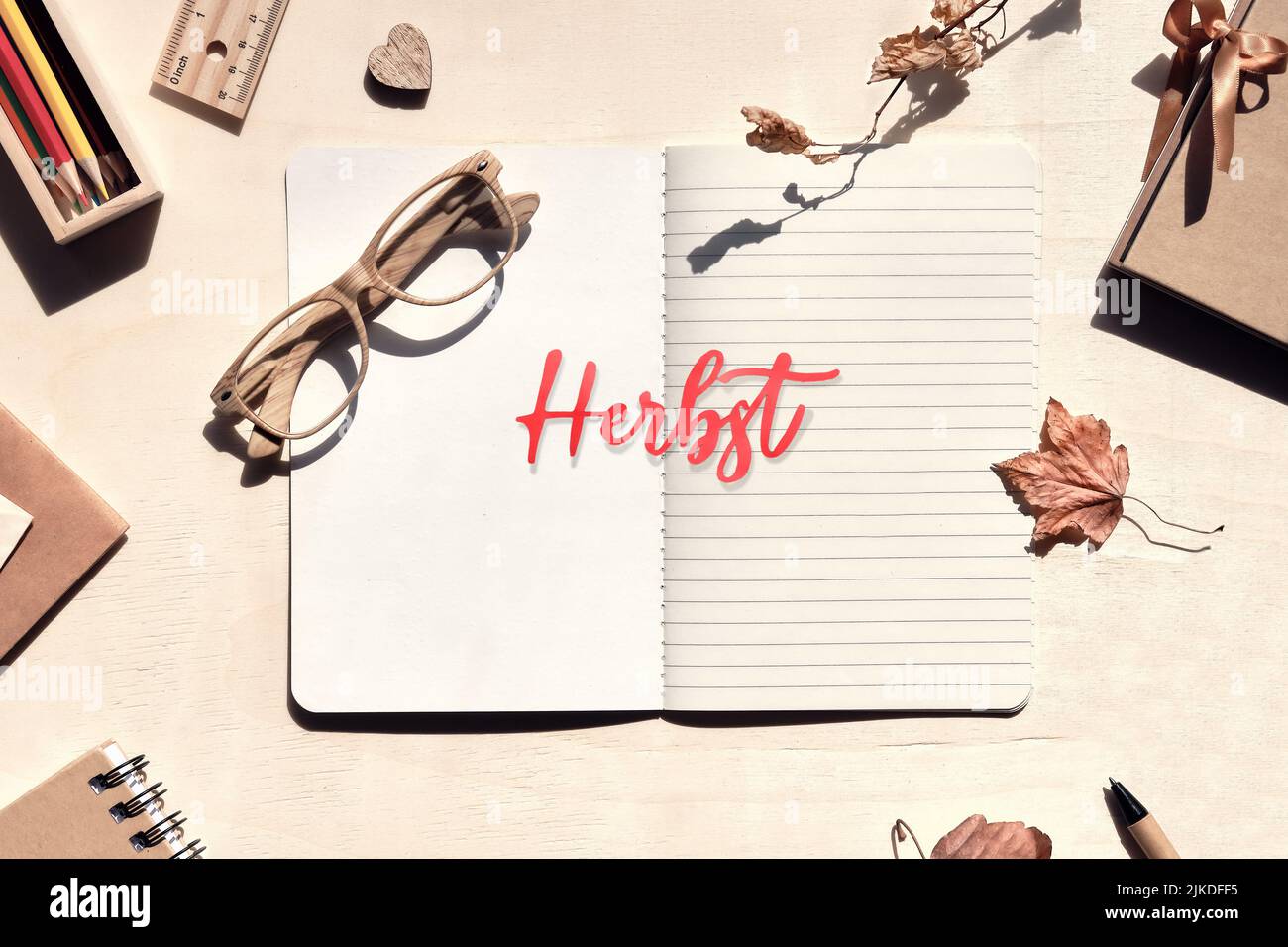 Word Herbst means Autumn in German. Wooden reading glasses, ruler, dry ...