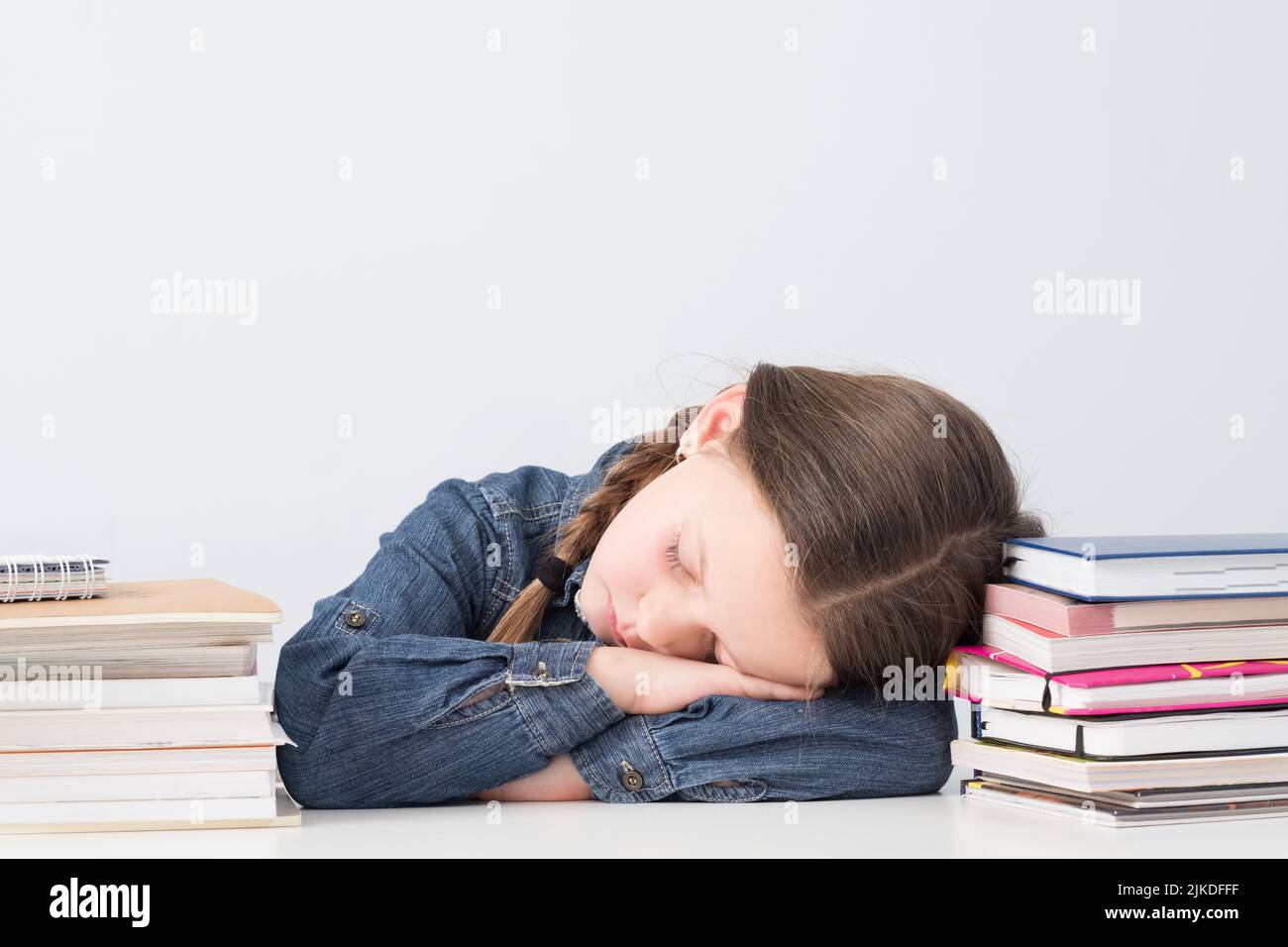 primary education school girl sleeping book stacks Stock Photo - Alamy