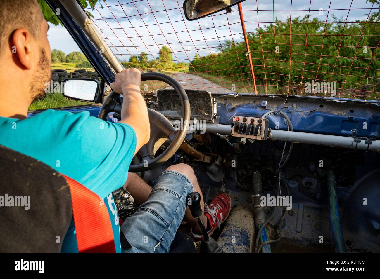 Taking fast autocross ride through the corn field at sunset, driving on ...