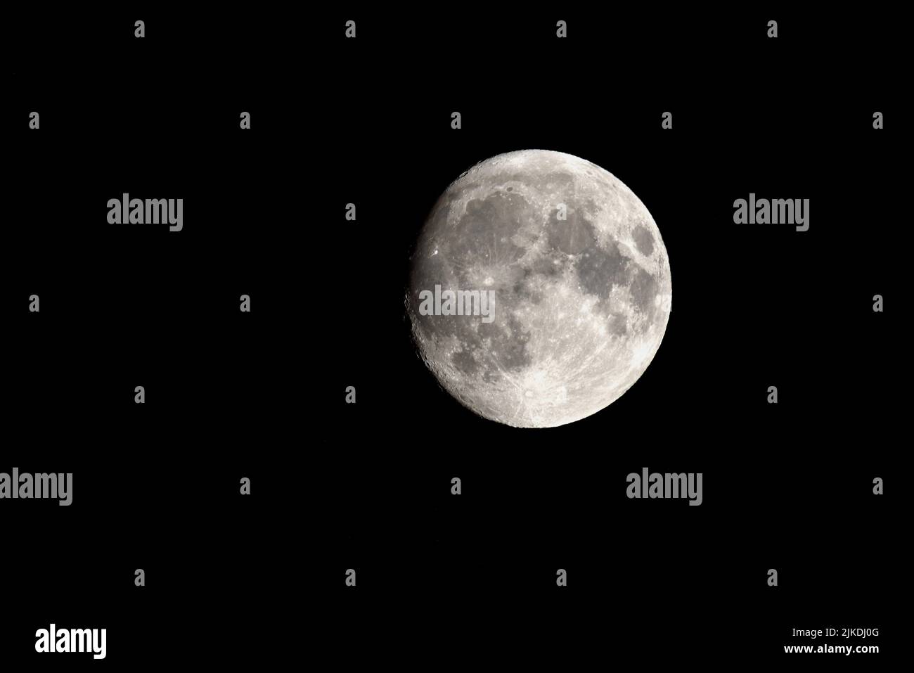 An almost full gray textured moon in a black sky Stock Photo - Alamy