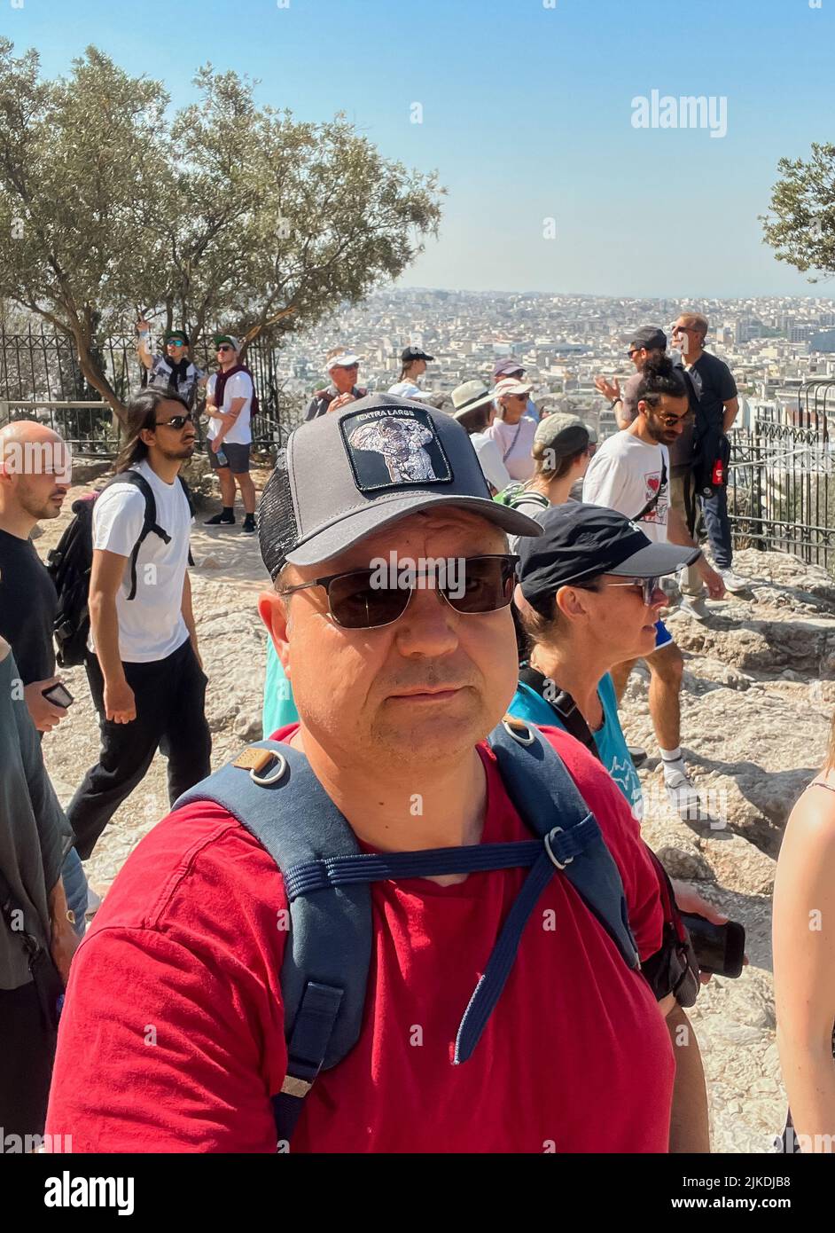 ATHENS, GREECE - MAY 14, 2022: A man in a baseball cap and red t-shirt ...