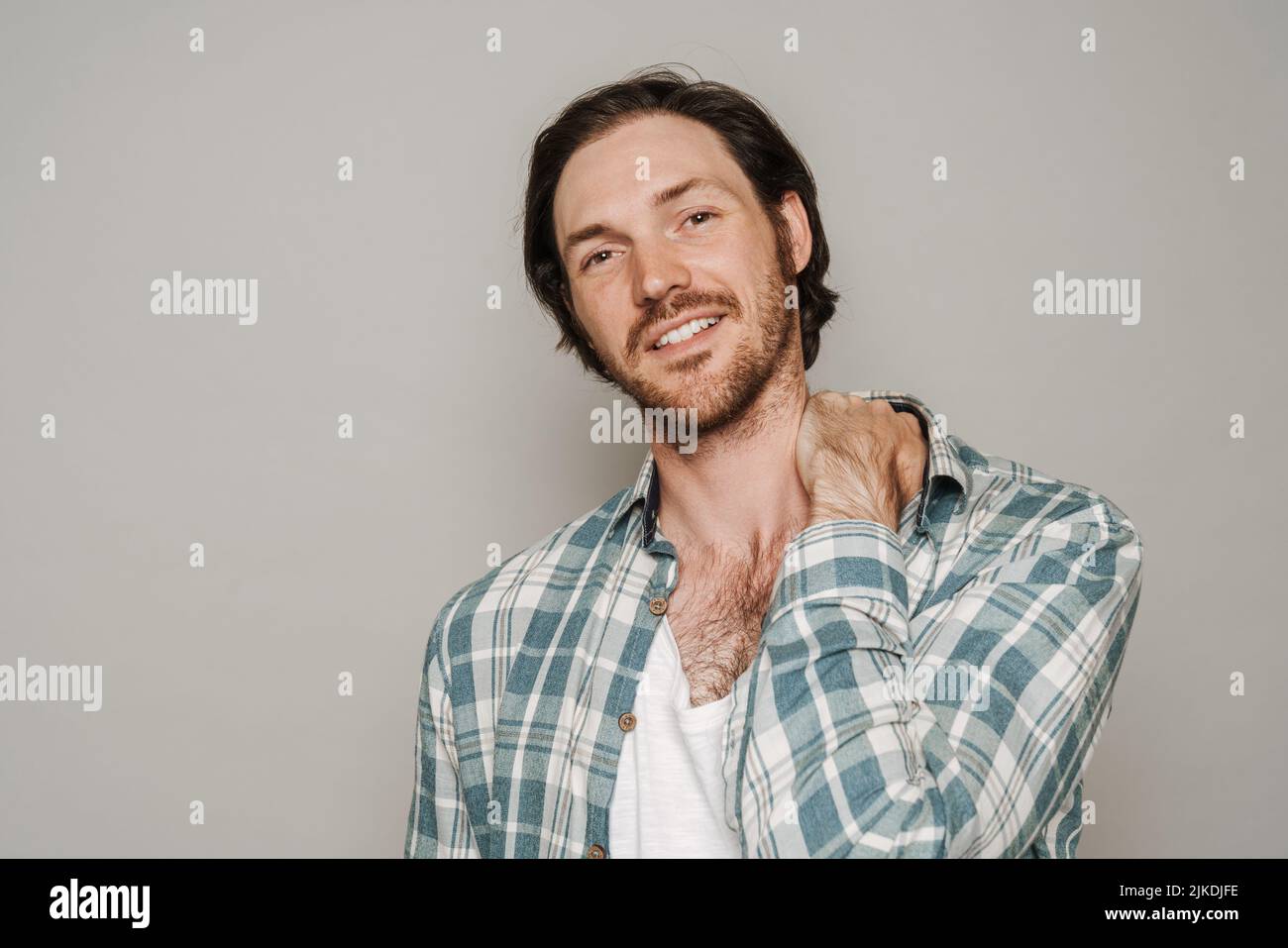 Bristle man dressed in shirt smiling while looking at camera isolated ...