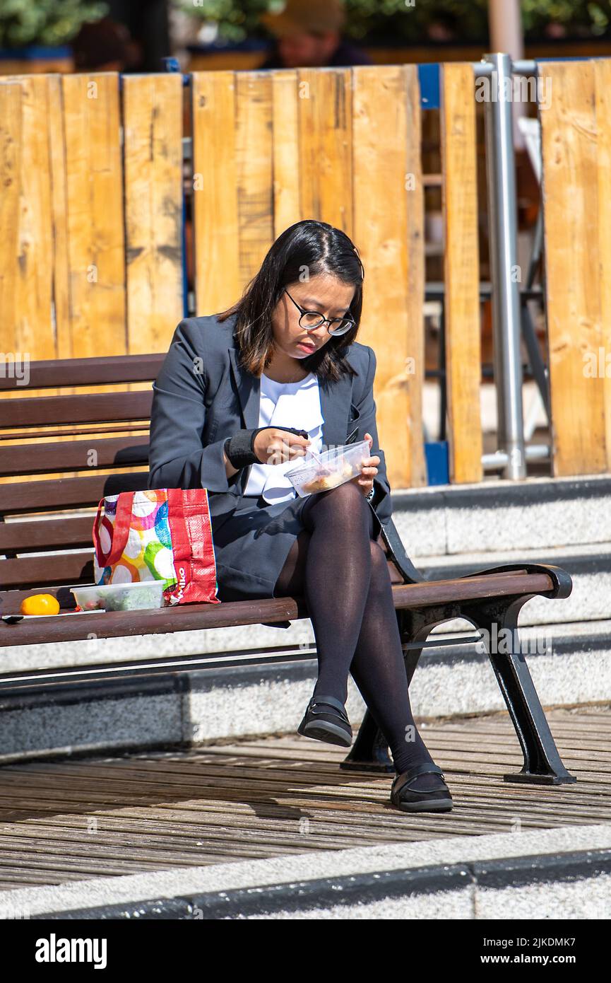 young woman sitting on a park bench resting, young woman sitting on ...