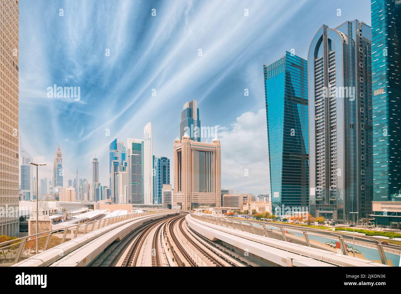 Metro road among glass skyscrapers in Dubai. Metropolitan railway among ...