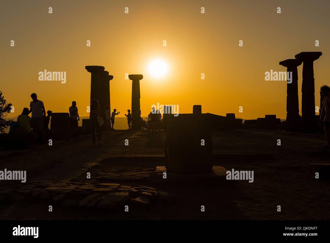 View of people and historical ruins at sunset captured in the temple of ...