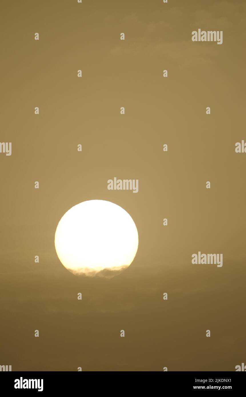 Sun through the clouds in a haze formed by airborne dust at dawn. Gran ...