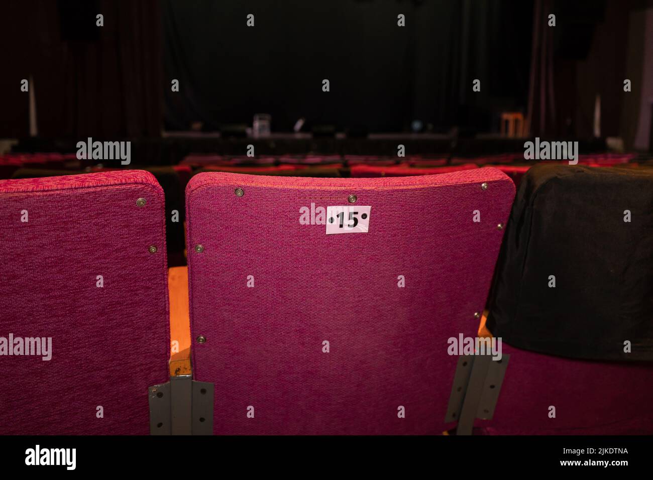 a view of theater seats with rear numbers and an empty stage Stock ...