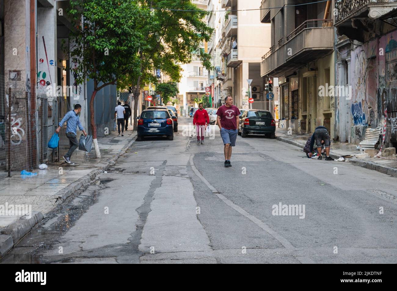 ATHENS, GREECE - MAY 14, 2022: A homeless man sleeps on a sidewalk in ...