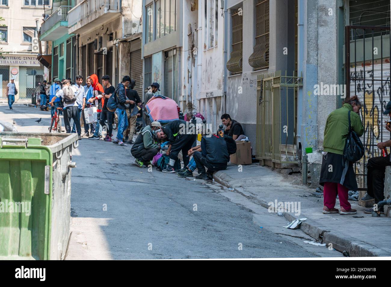 ATHENS, GREECE - MAY 14, 2022: A homeless man sleeps on a sidewalk in ...