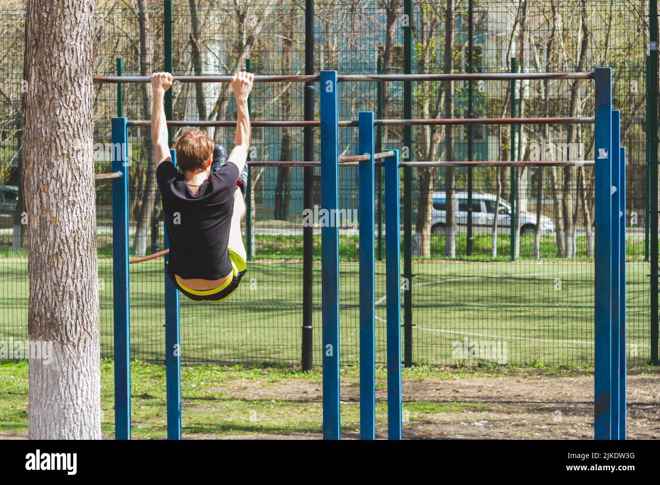 Sports. A man is engaged in a horizontal bar. Outdoor pull-ups. Sports ...