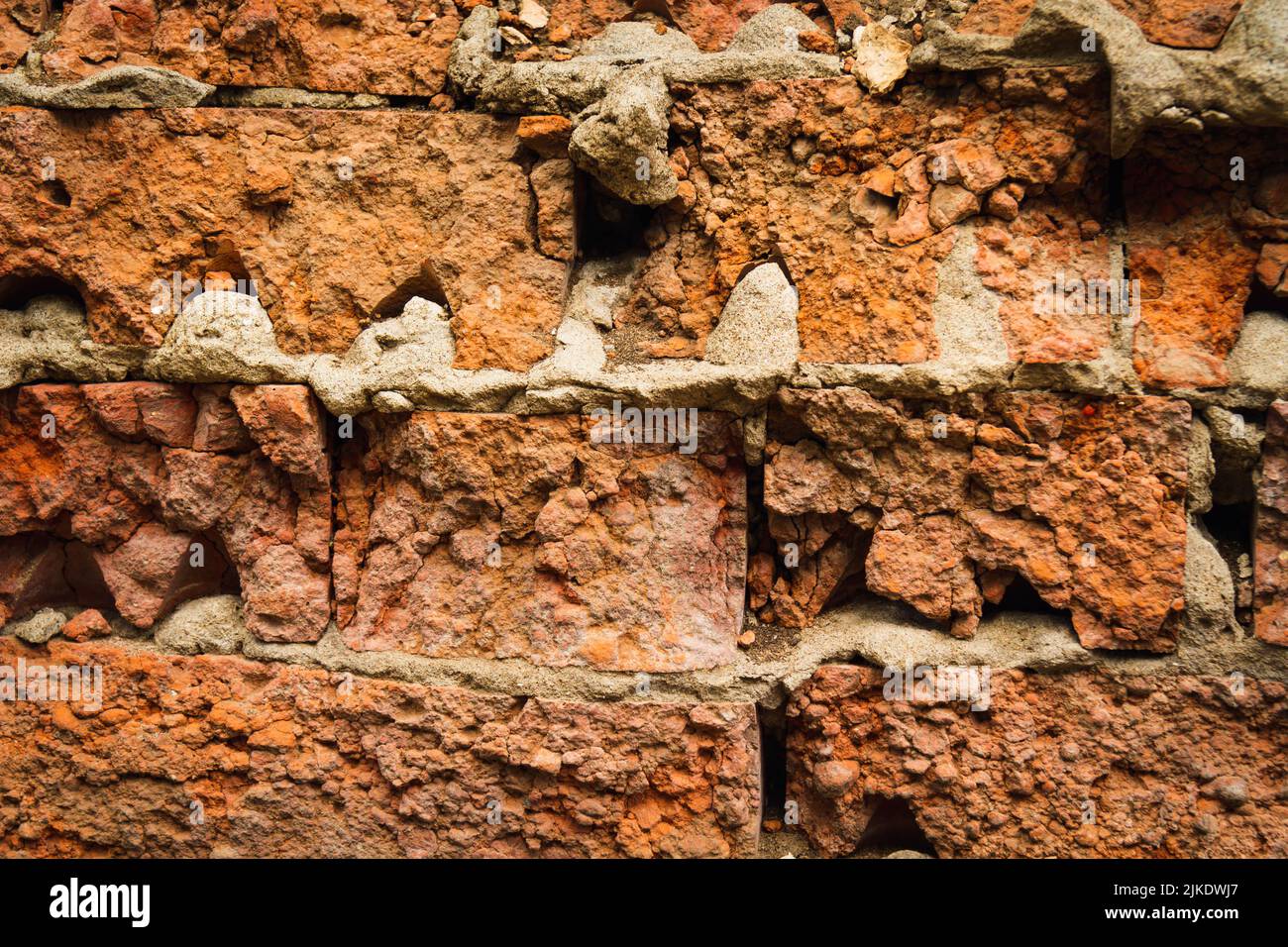 Red brick wall. Destruction after the demolition of the house. Remains ...