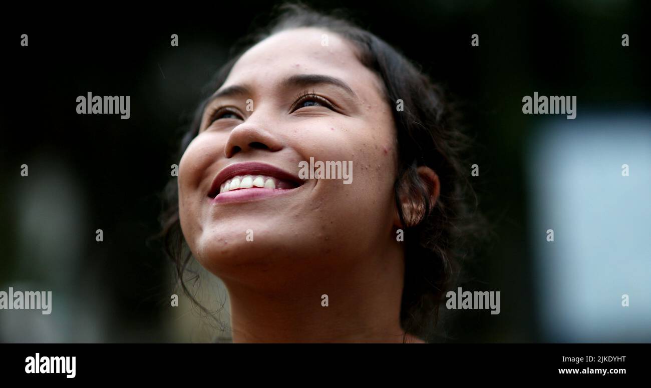 Young woman face opening eyes in meditation and contemplation loooking ...