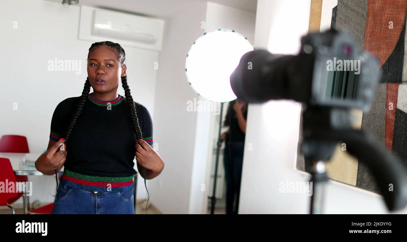 Young woman vlogging in front of camera tripod Stock Photo - Alamy
