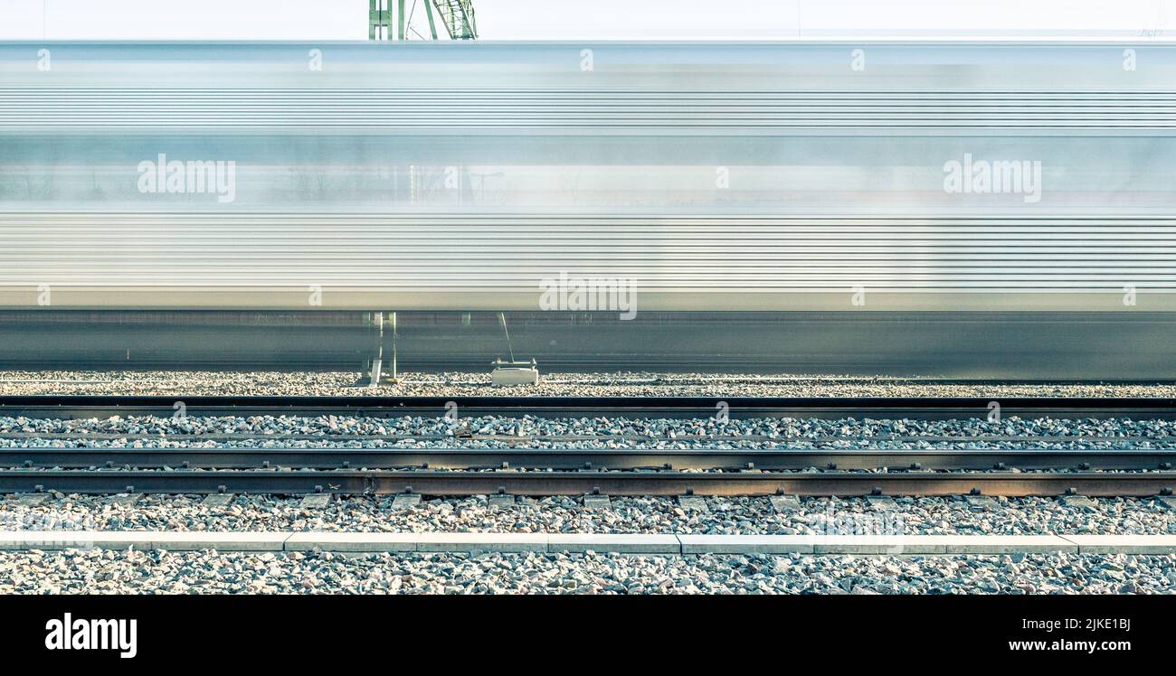 Fast passenger express train passing a station Stock Photo - Alamy