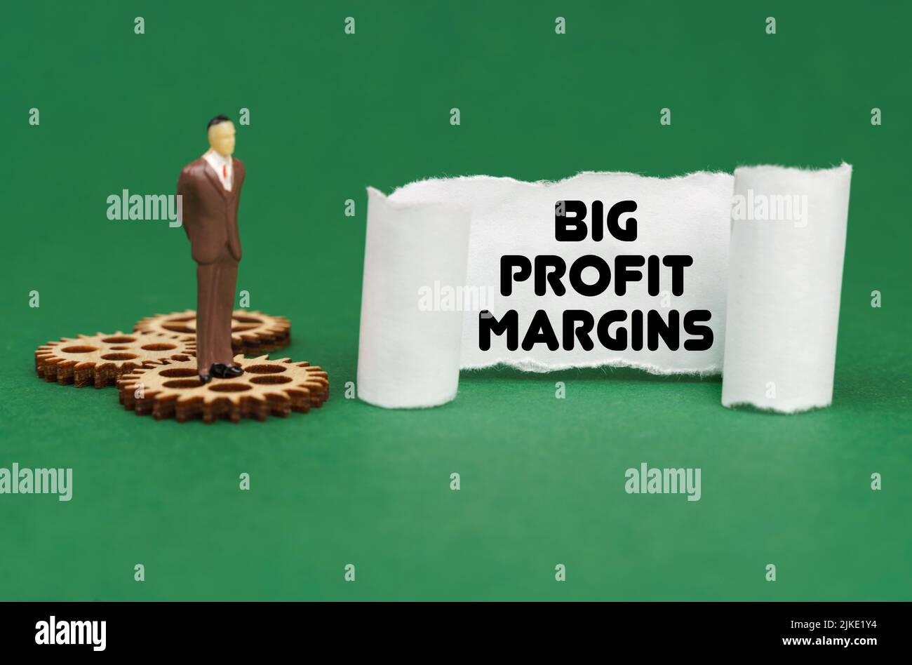 Business concept. The figure of a man stands on the gears and reads the ...