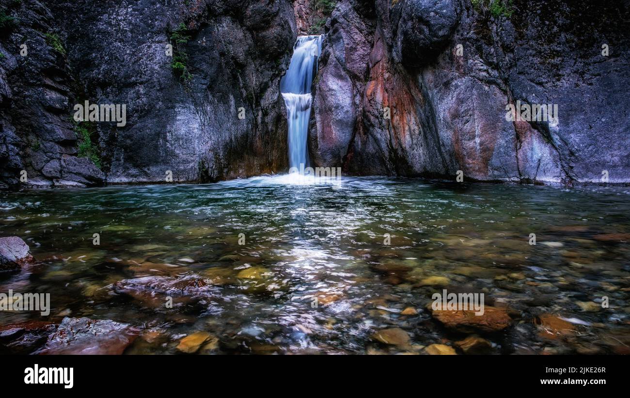 Cat Creek Waterfalls with a dead log in the creek. The location was ...
