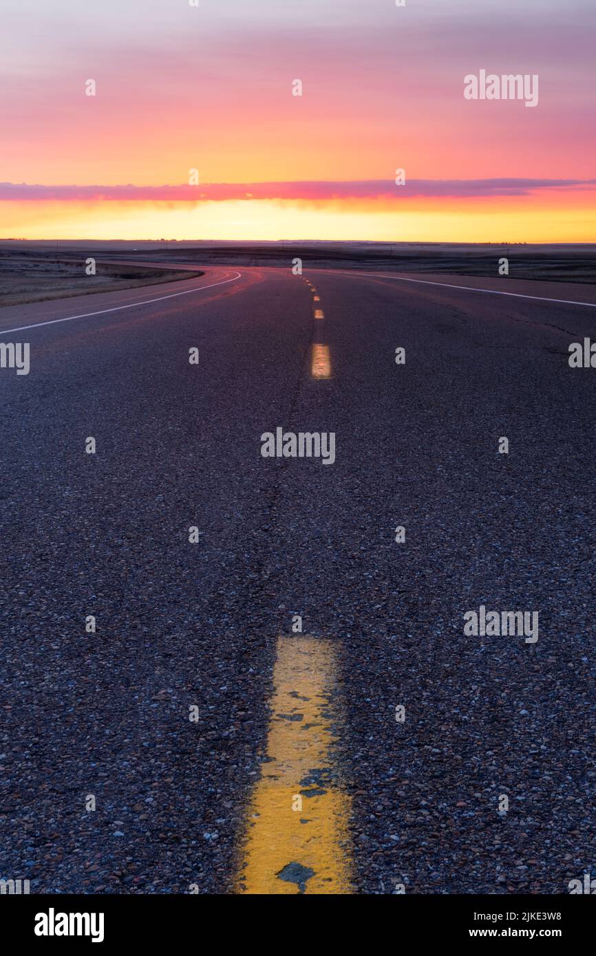 The leading yellow line leads to a curve with a sunrise on the horizon ...