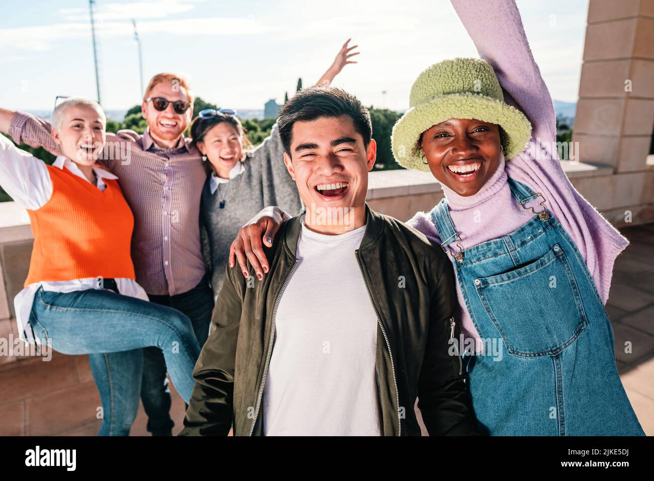 Portrait of couple of diverse friends smiling in front of the camera ...