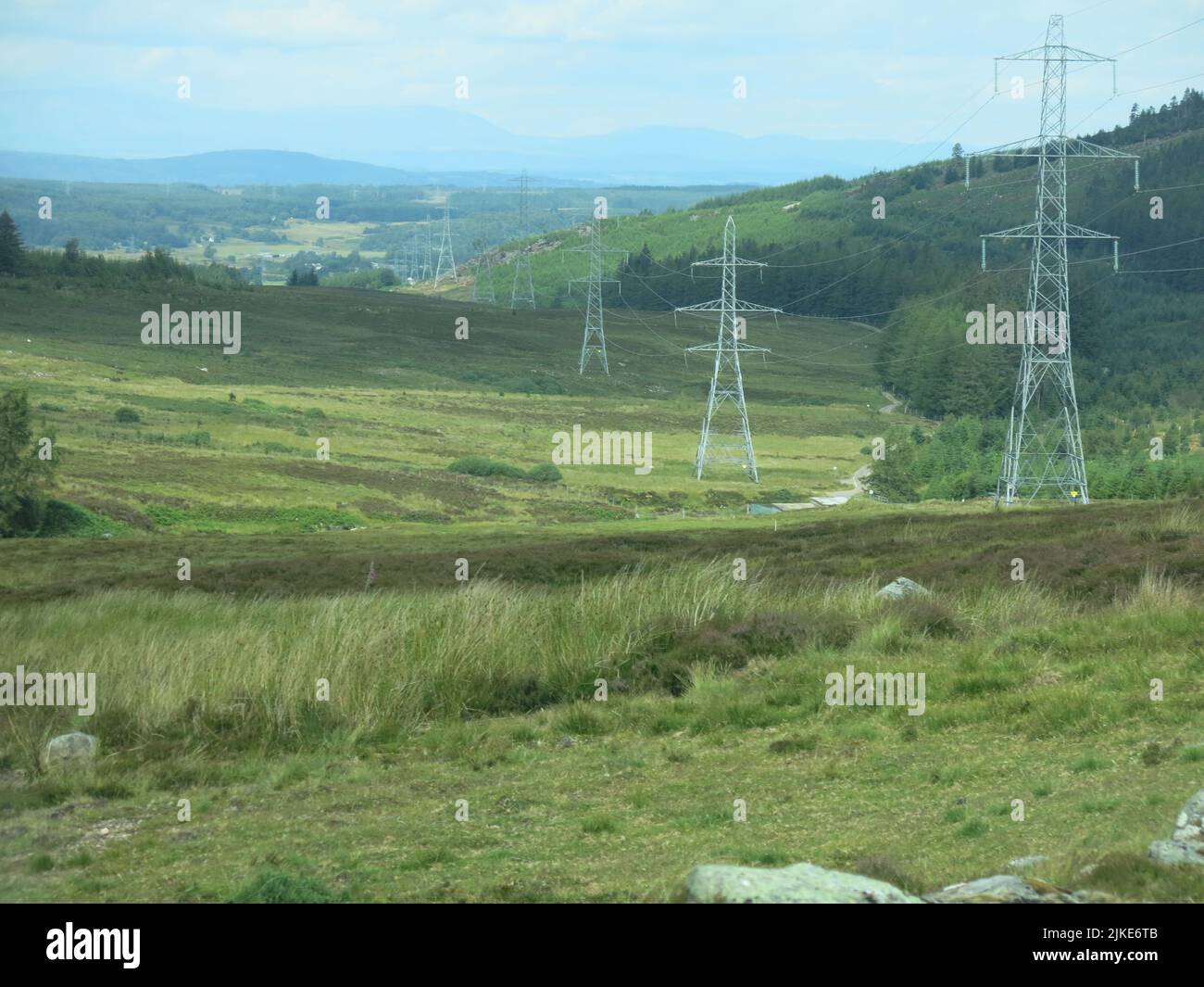 Electricity pylons march across the moorland landscape at Strathdearn ...