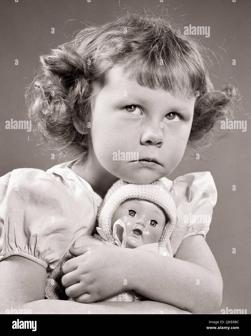 Child clutching doll hi-res stock photography and images - Alamy