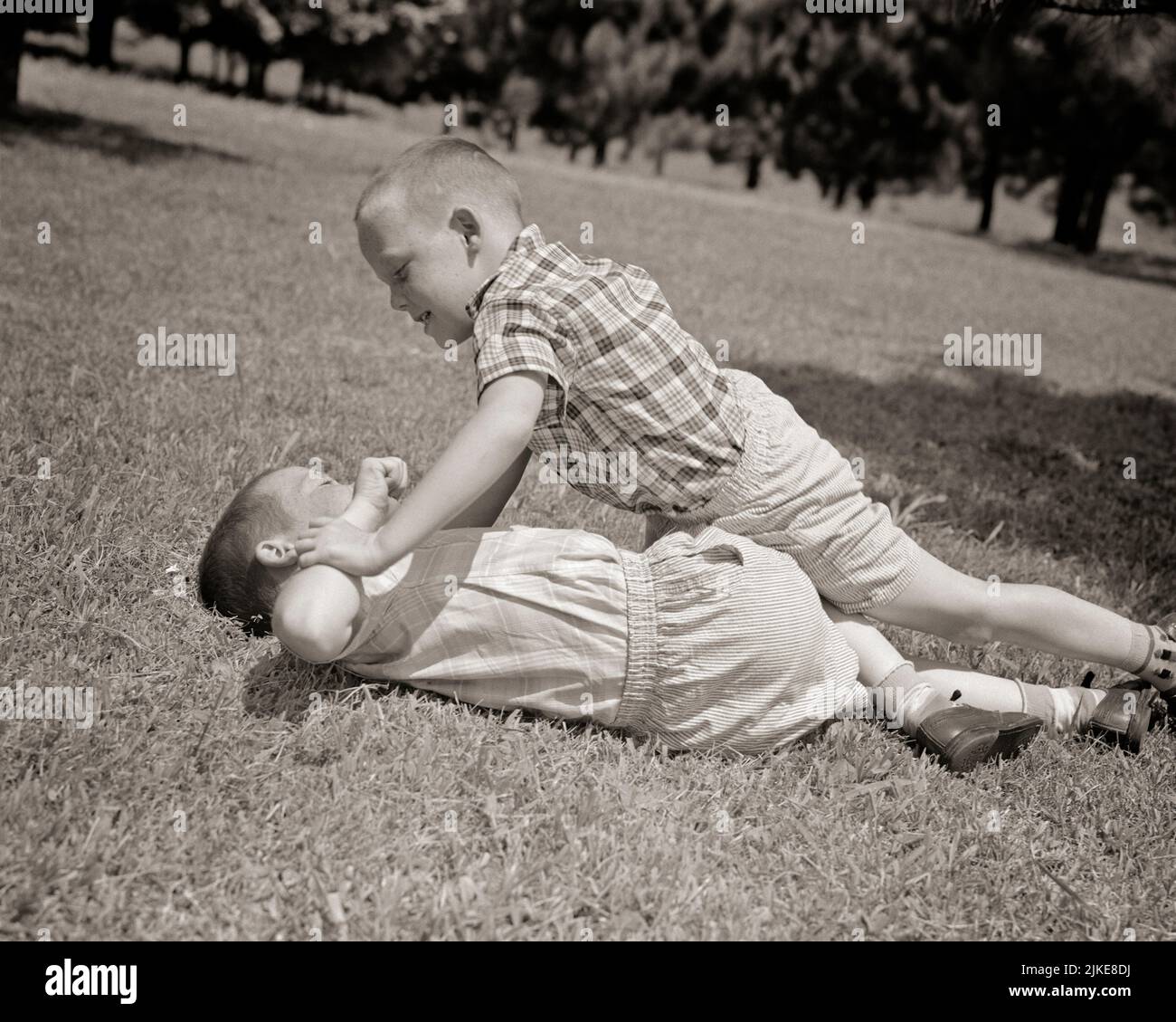 Two brothers fighting in the yard hi-res stock photography and images ...