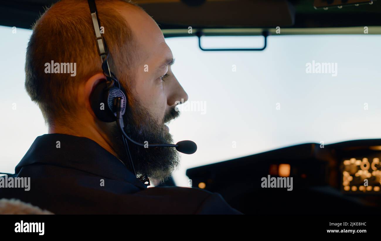 Male captain pilot flying airplane with dashboard command, using aerial ...