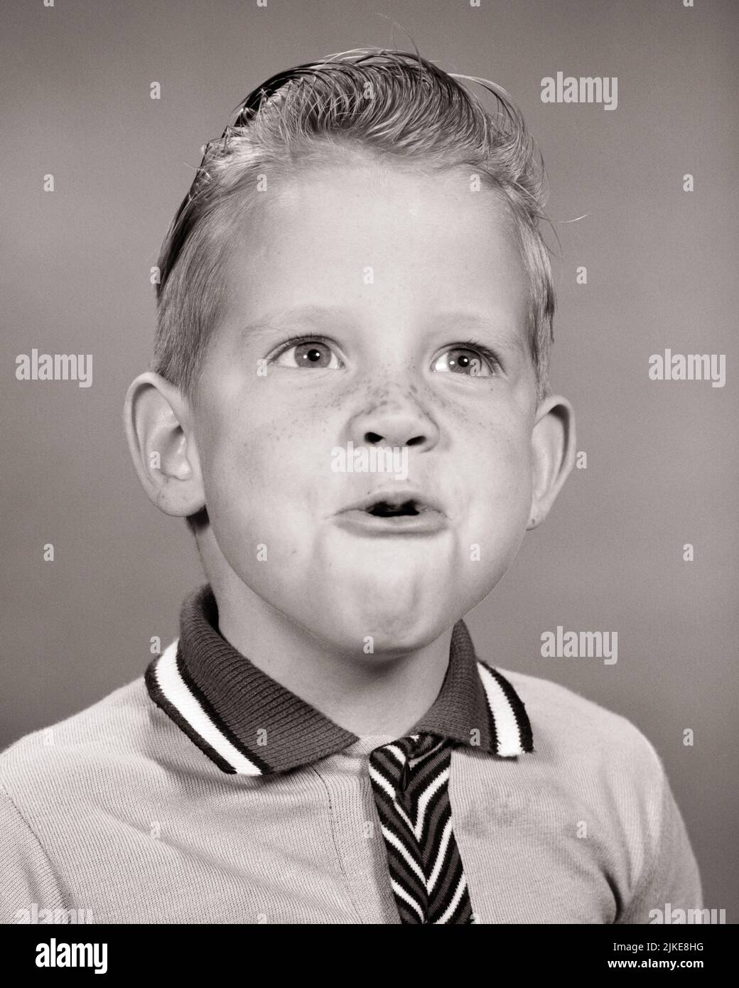 1960s BOY MAKING A FUNNY FACIAL EXPRESSION JUST READY EAGER TO GET INTO ...