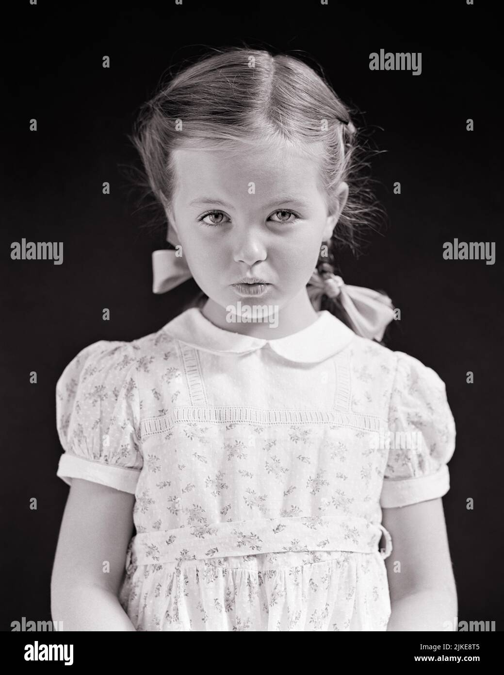 1940s TIMID LITTLE GIRL WITH PIGTAIL BRAIDS & BOWS LOOKING OFF CAMERA ...