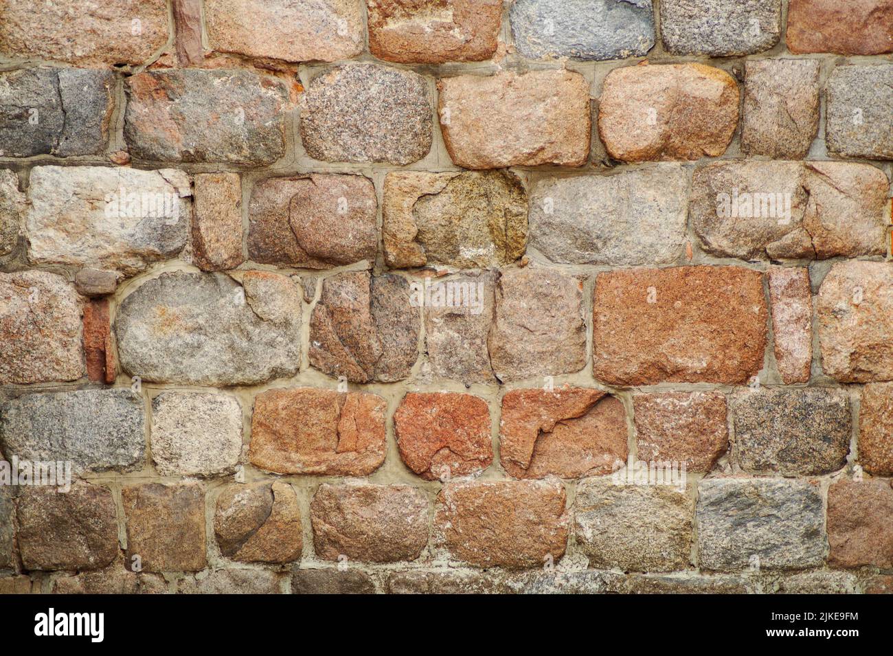 an old wall made of cobblestones and large stones of various shapes and ...