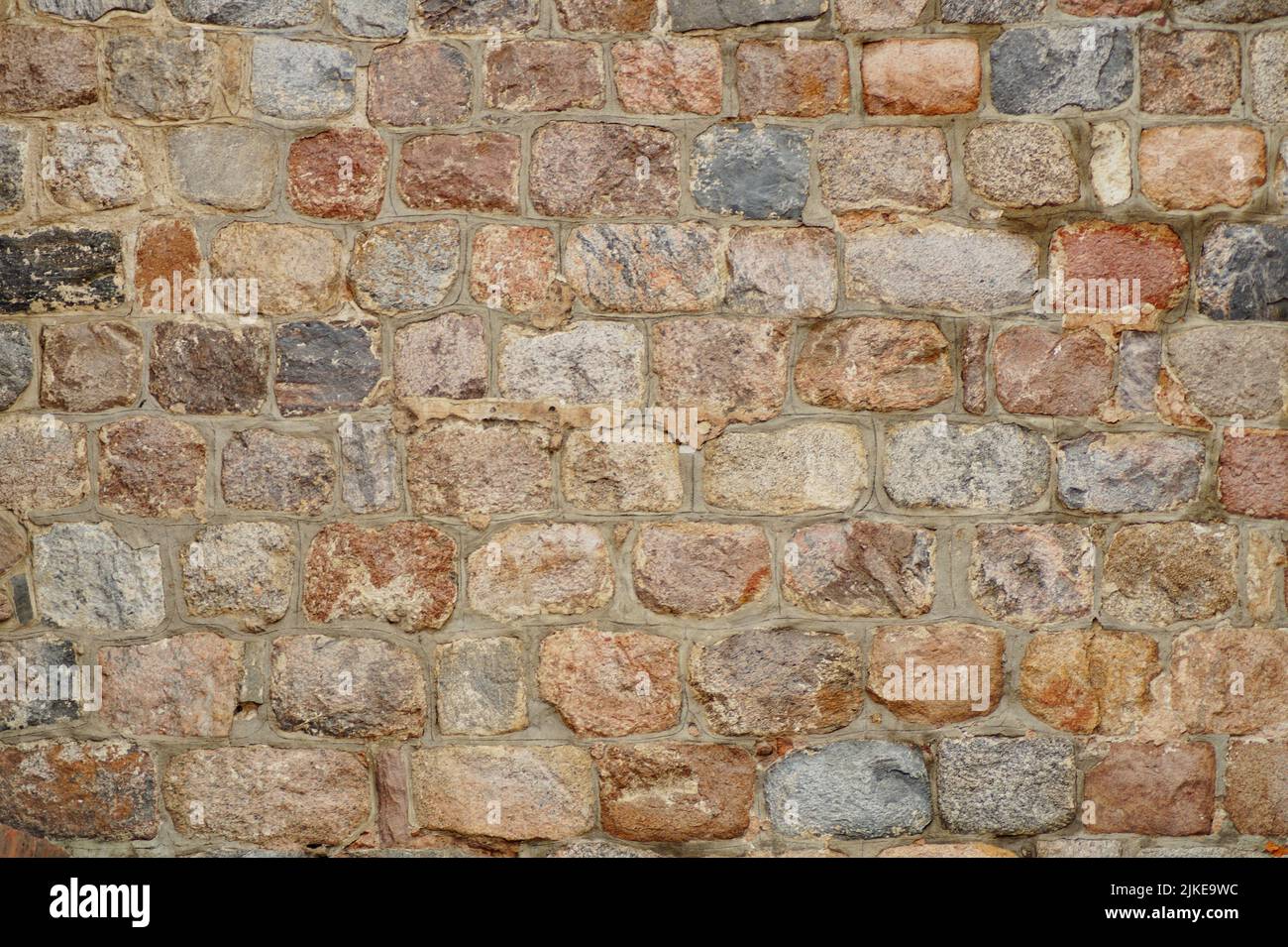 ancient masonry of stones, the wall of an ancient castle. Horizontal ...