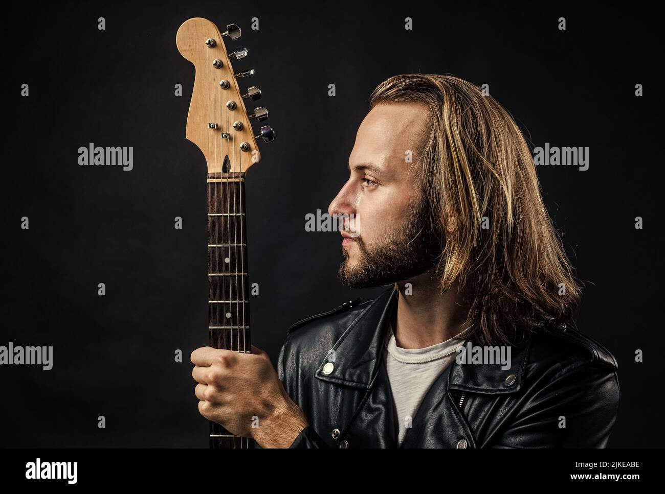 guitar neck. man long hair hold electric guitar fingerboard. rock music ...