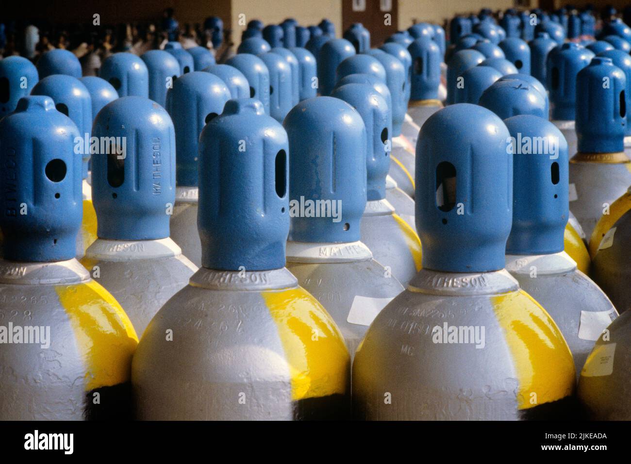 1980s LIGHT BLUE AND YELLOW PAINTED INDUSTRIAL GAS CYLINDERS INDICATING ...