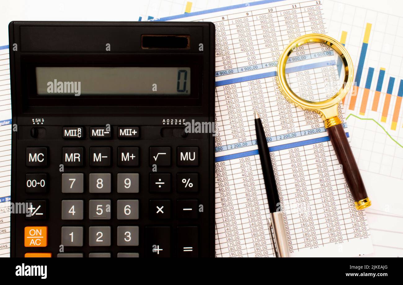 Business concept with magnifying glass, calculators and documents Stock ...