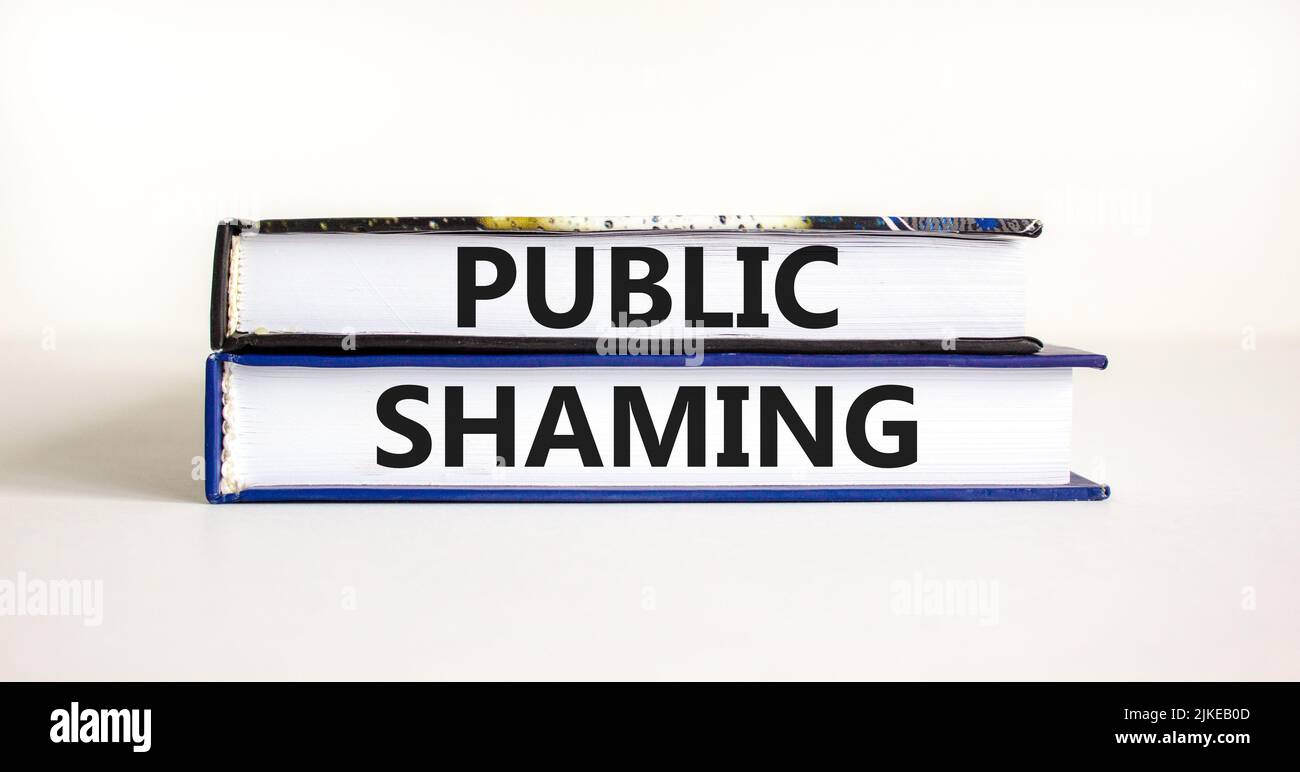 Public shaming symbol. Concept words Public shaming on books on a ...