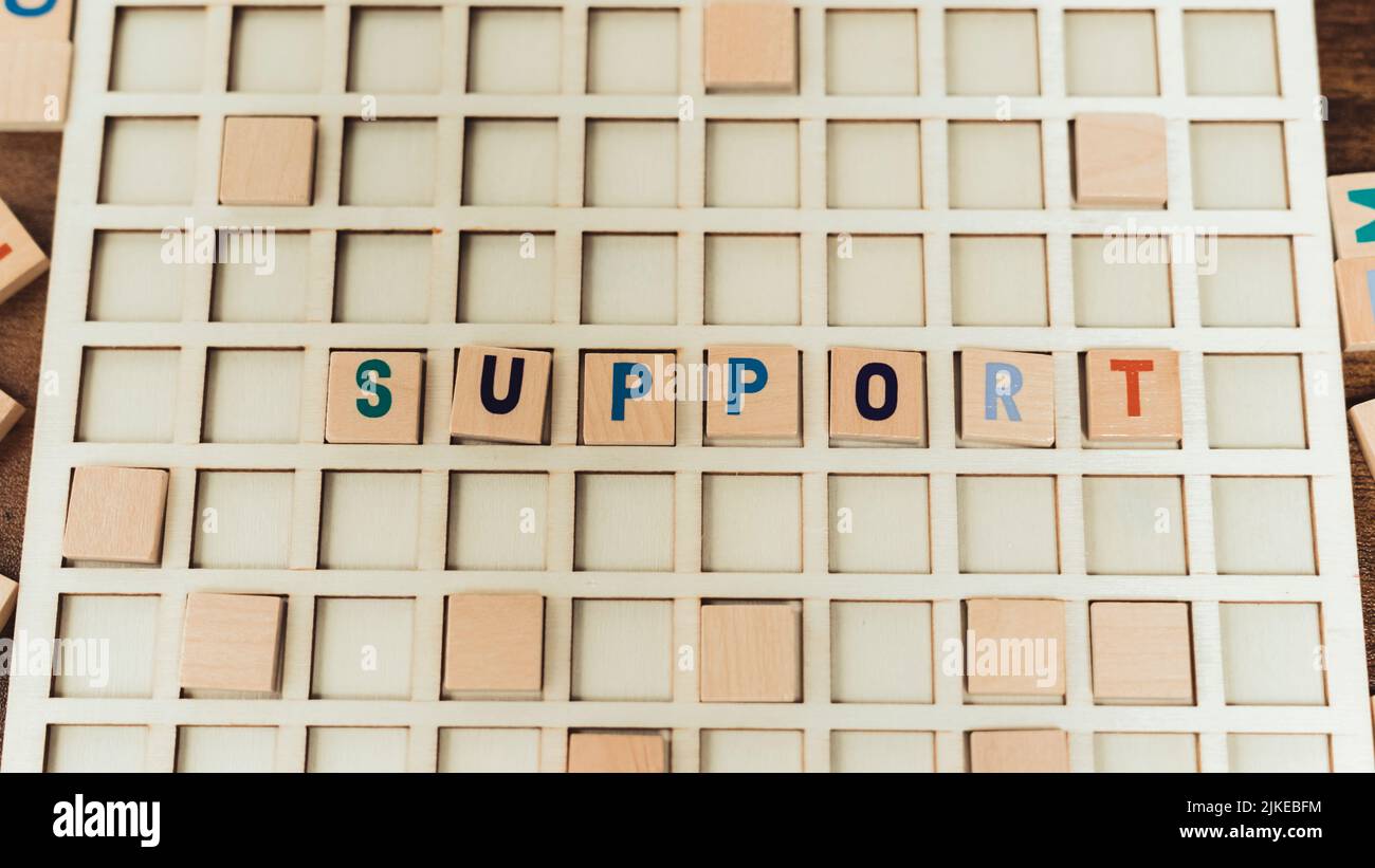Support. Word puzzles concept. Square cube colourful letters on a ...