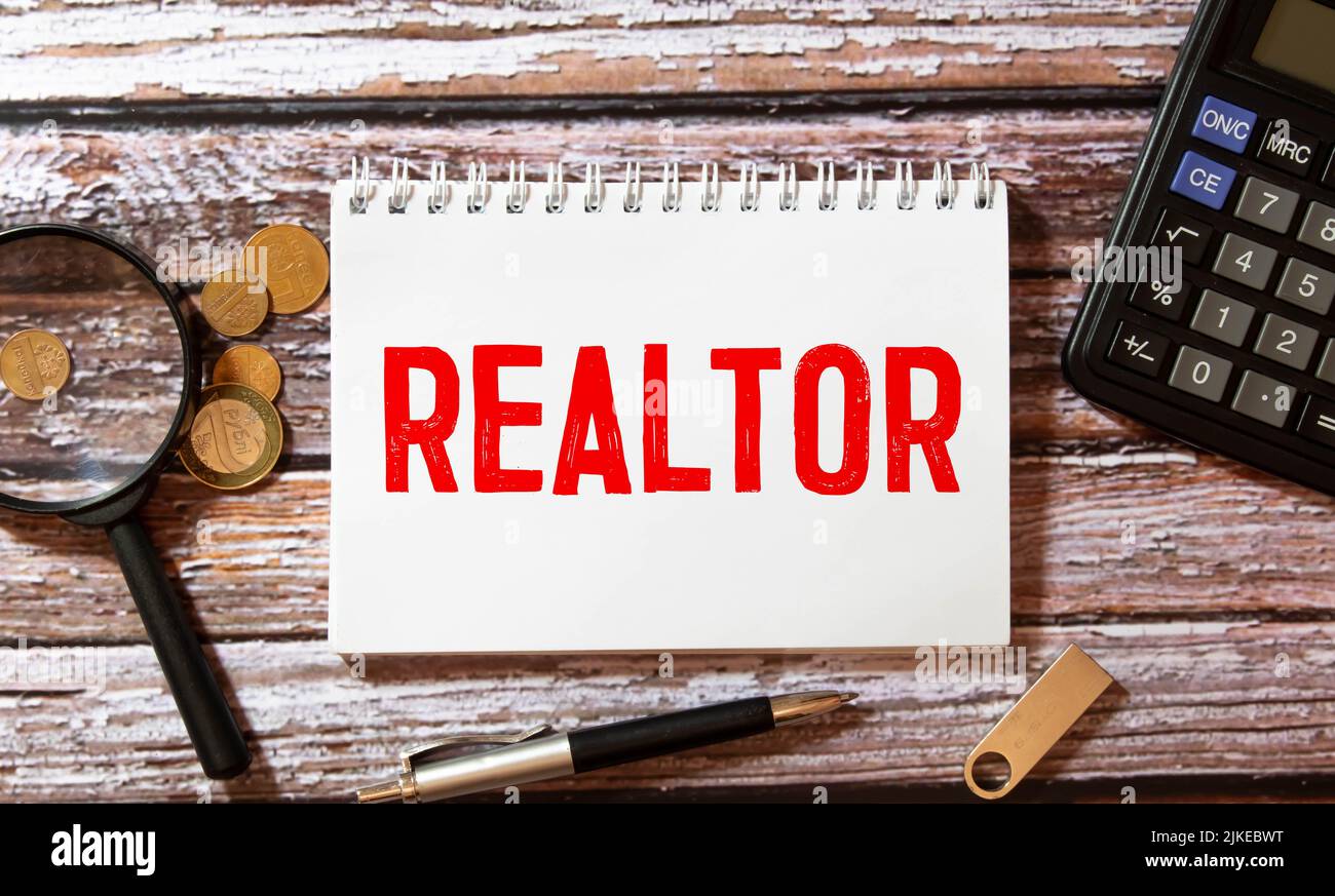 Cubes form the word realtor in front of a miniature house Stock Photo ...