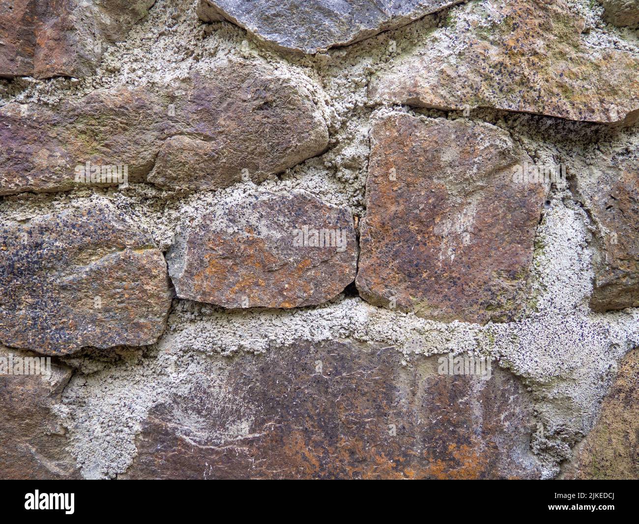 Ancient stonework. The stones are reinforced with old mortar. Uneven ...