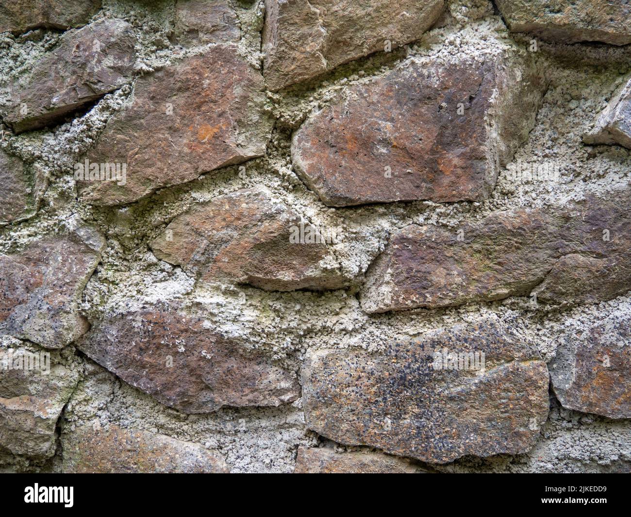 Ancient stonework. The stones are reinforced with old mortar. Uneven ...
