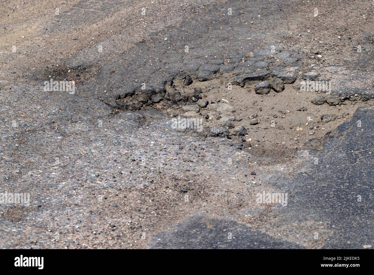 poor paved road with a lot of holes and potholes, poor transport ...