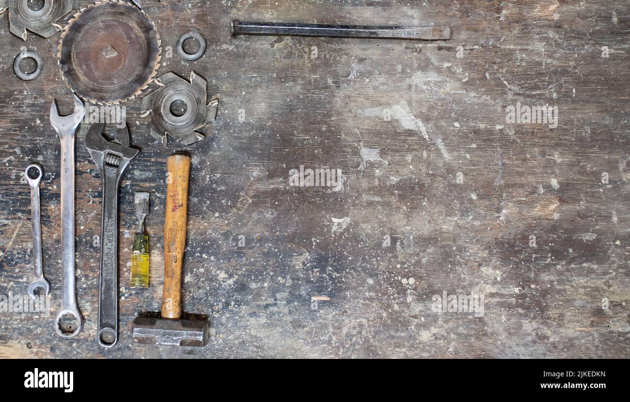 old wooden table with texture and carpentry and mechanic tools and saws ...