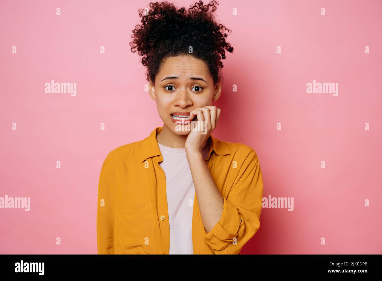 Confused worried african american young woman, in casual wear, looking ...