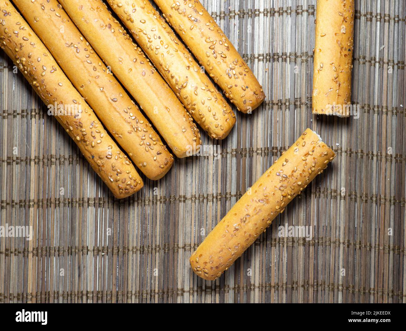 Sesame biscuits and bread on the table. Biscuits are elongated in the ...