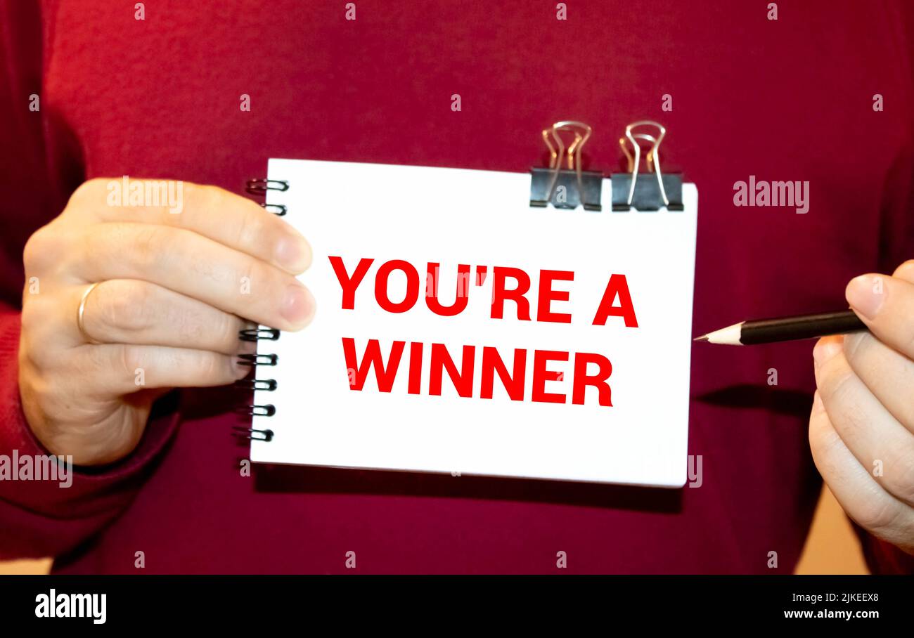 white paper with text You Re A Winner on a yellow background with ...