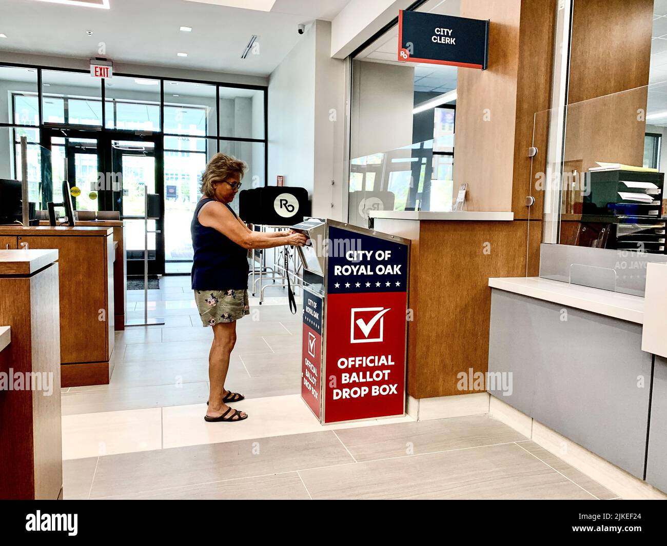 Royal Oak, Michigan, USA. 1st Aug, 2022. A Michigan voter drops her ...