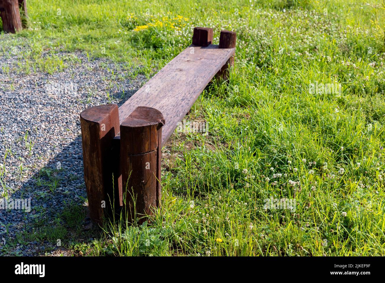 A simple wooden bench in the park, a bench made of wood for relaxing in ...
