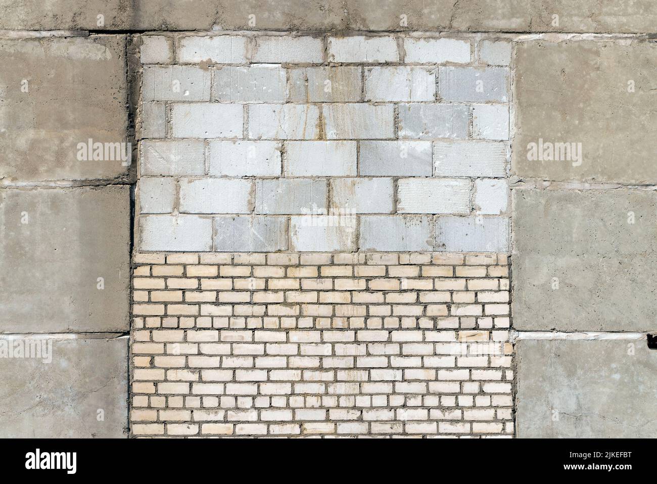an old brick wall made of a large number of different types of bricks ...