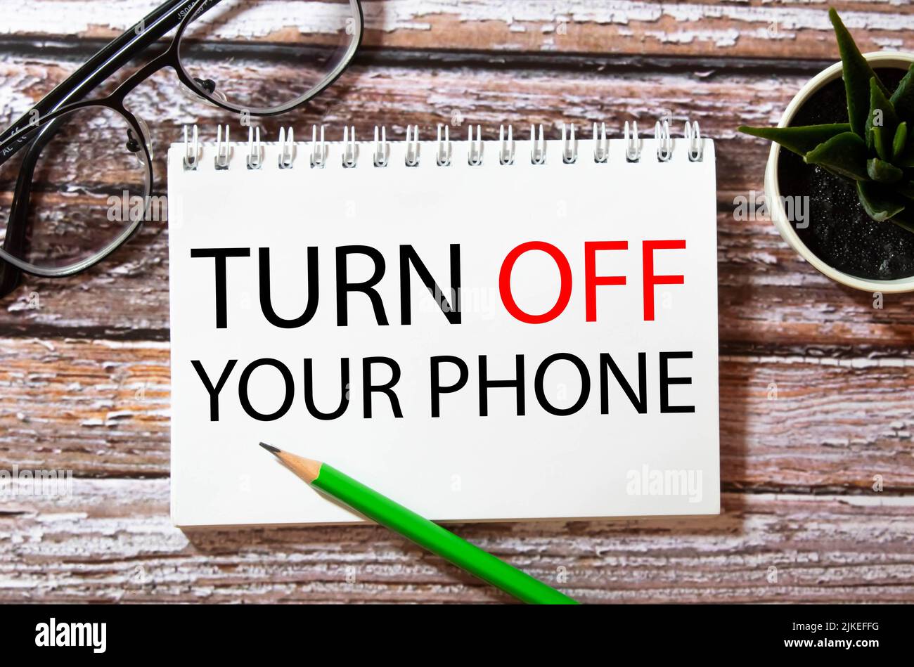 Business man pointing the text Turn Off Your Phone Stock Photo - Alamy