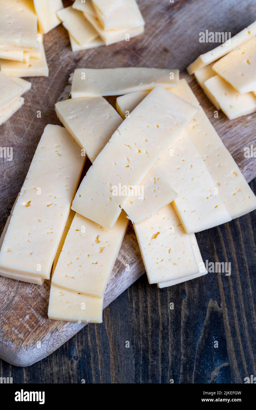 cut into pieces real hard cheese with lots of milk, the product of milk ...